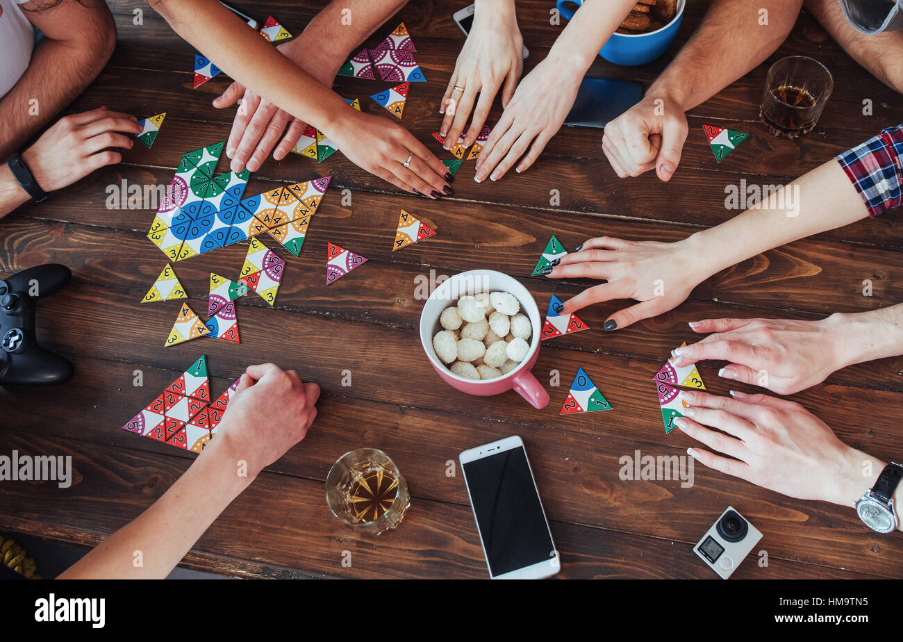 Top view creative photo of friends sitting at wooden table. having fun ...