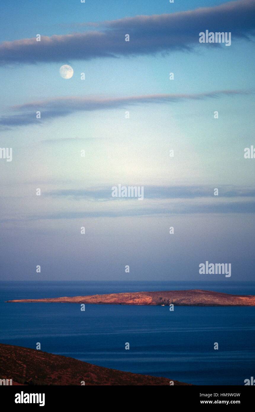 Islet, clouds and full Moon in the background, Palekastro, Crete ...