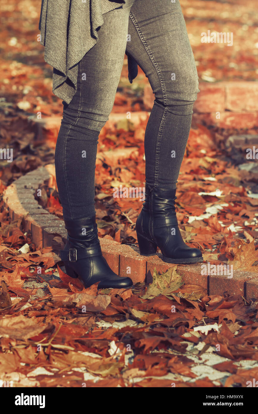 Woman's legs in black jeans and black high heel boots standing in the ...