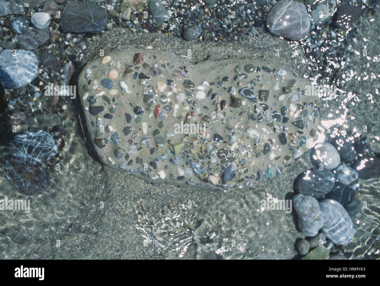 Pebbles and sand being lapped by the water, Crete, Greece Stock Photo ...