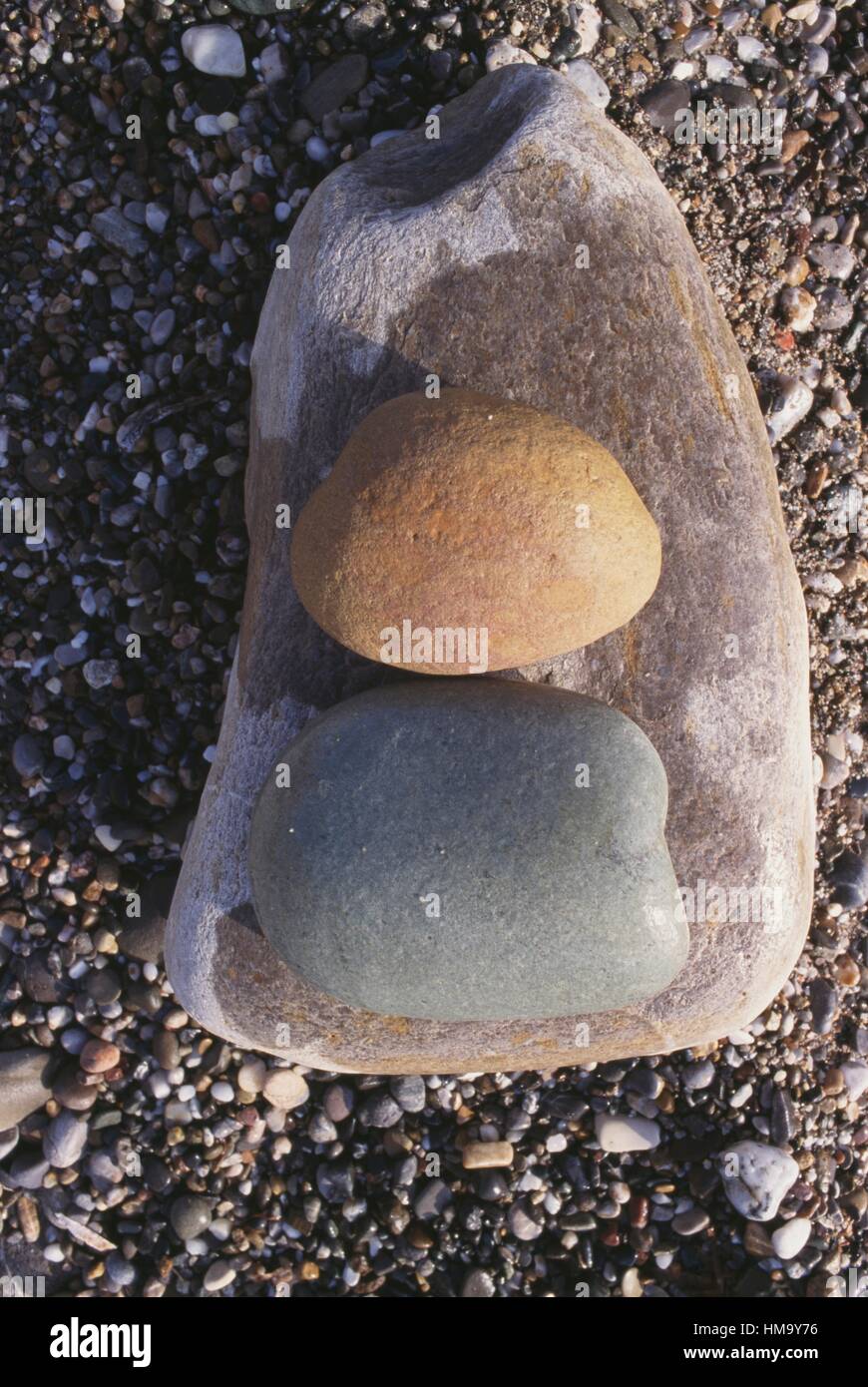 Small rocks piled on a larger rock sitting on gravel, Crete, Greece ...