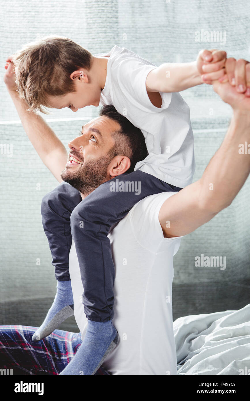 Father carrying son on neck Stock Photo - Alamy