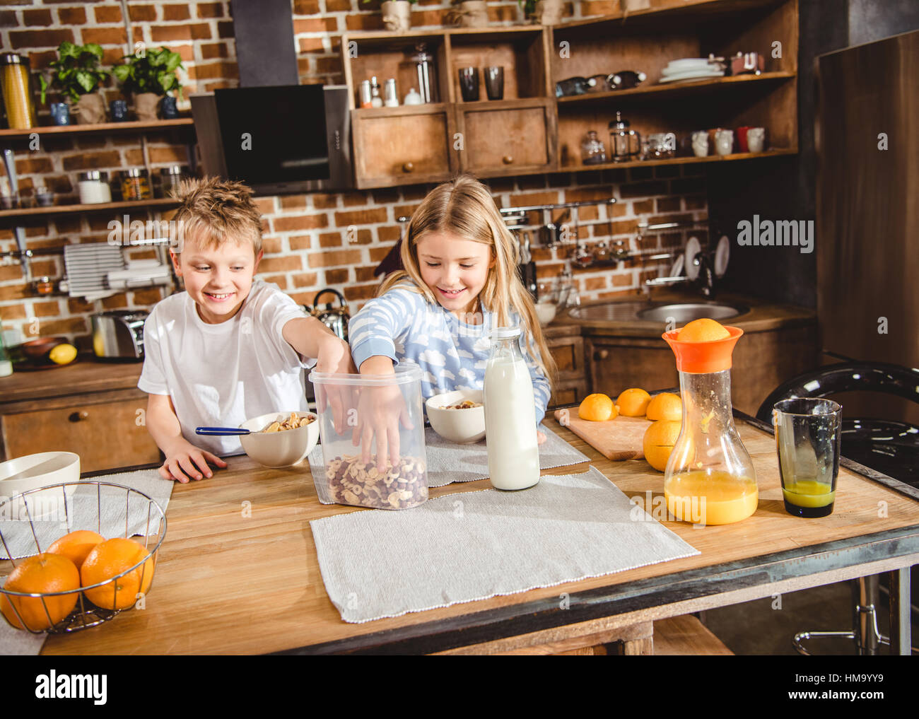 Siblings have breakfast Stock Photo - Alamy