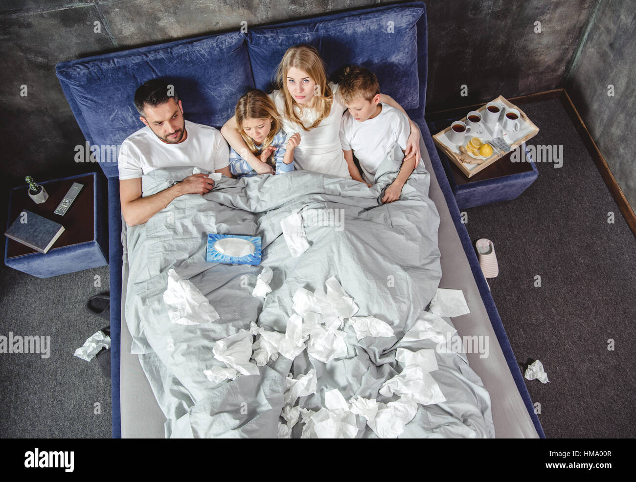 Sick family on bed Stock Photo - Alamy