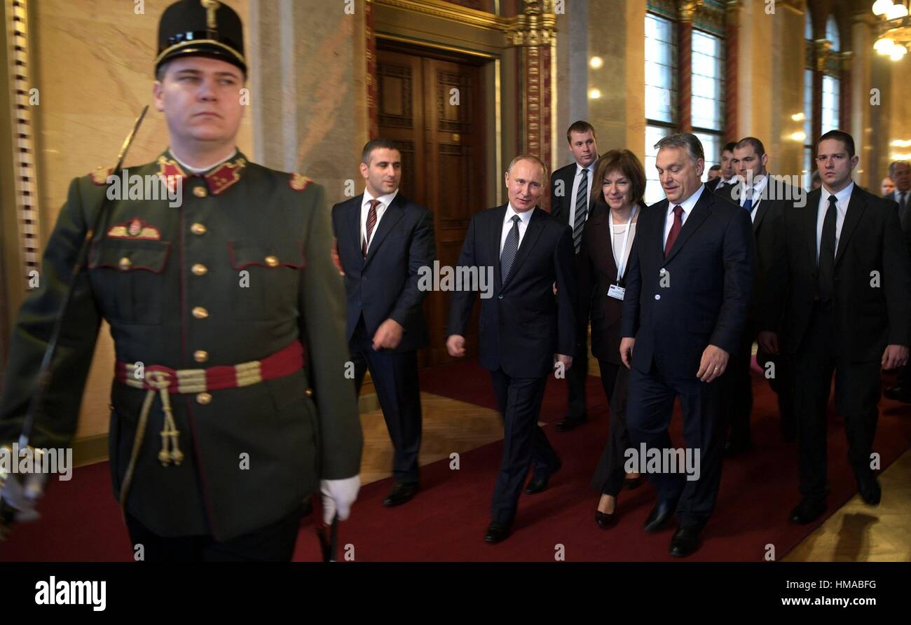 Russian President Vladimir Putin walks with Hungarian Prime Minister ...