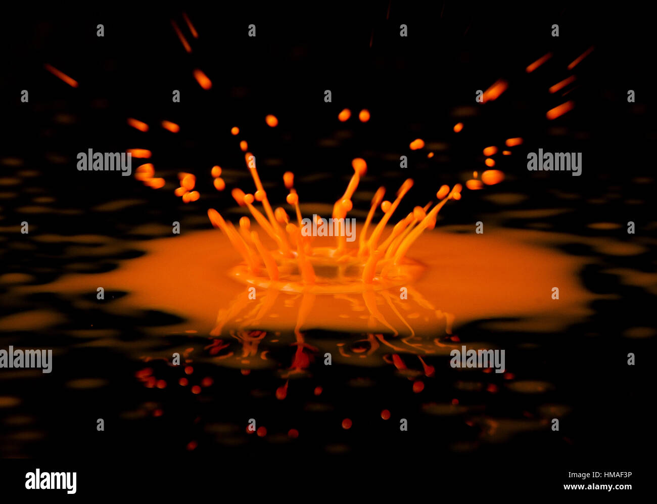 Colorful paint drop splashing on black a background Stock Photo - Alamy