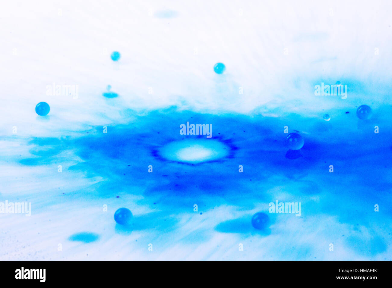 Colorful paint drop splashing on black a background Stock Photo - Alamy