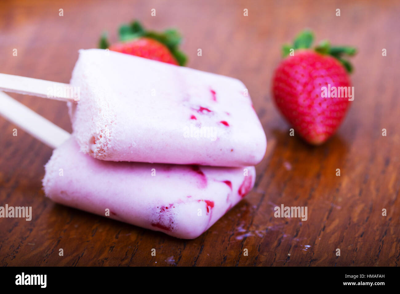 Homemade strawberry ice lolly on a rustic background Stock Photo - Alamy