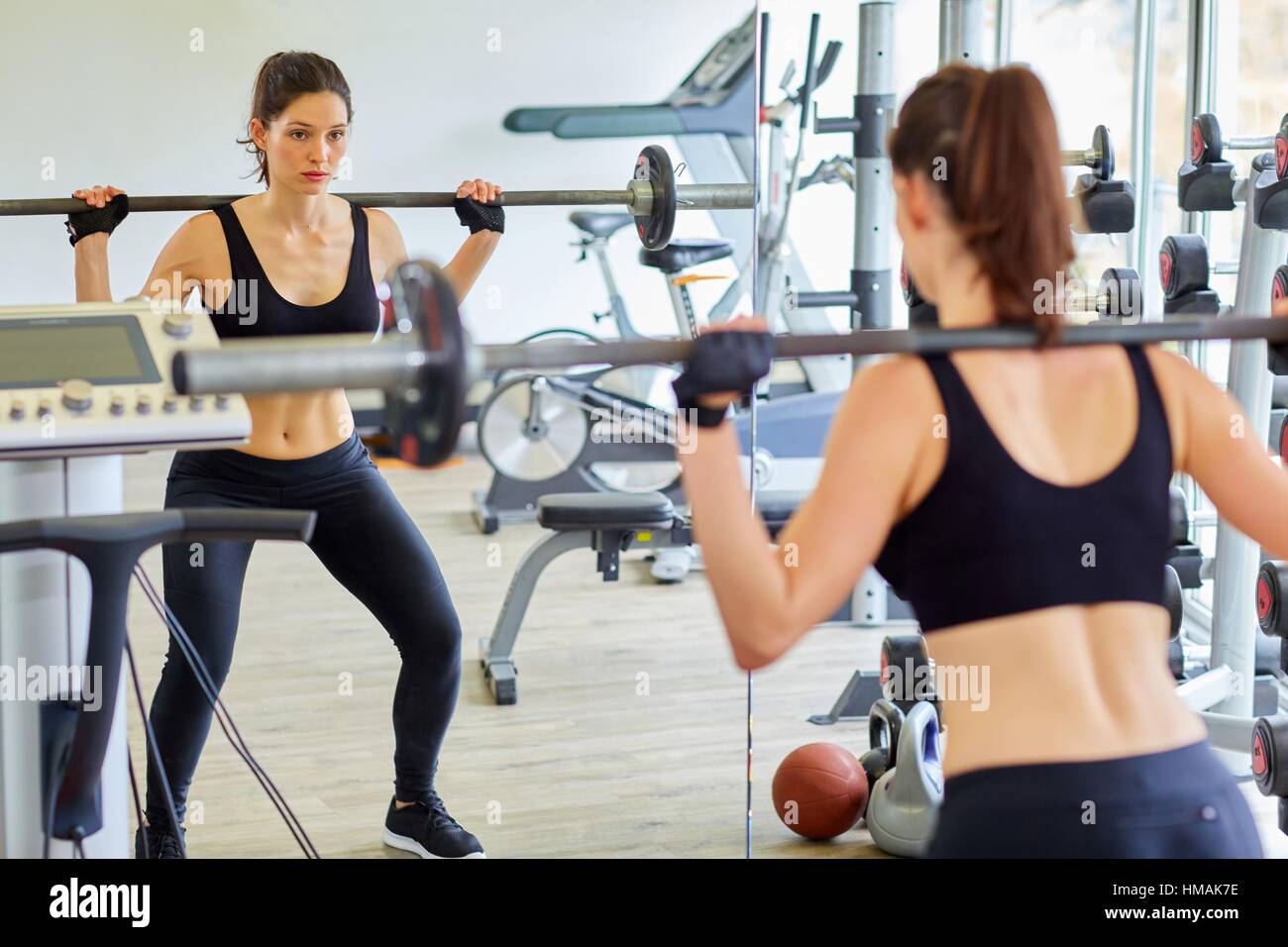 Dumbbells, Woman lifting weights at the gym Stock Photo - Alamy