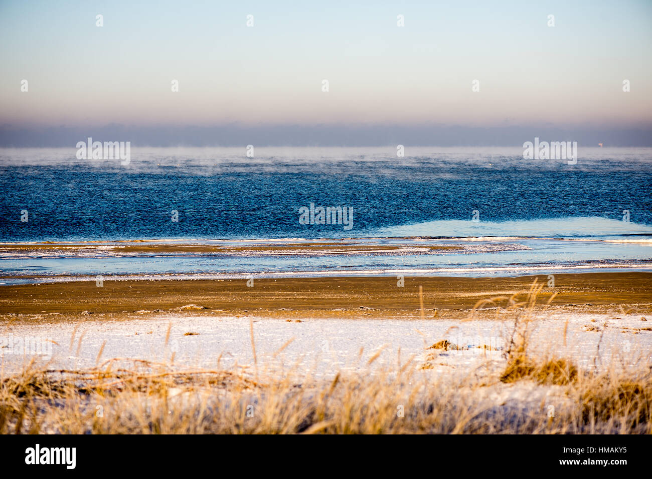 frozen beach view by the baltic sea with sand and ice in water Stock ...