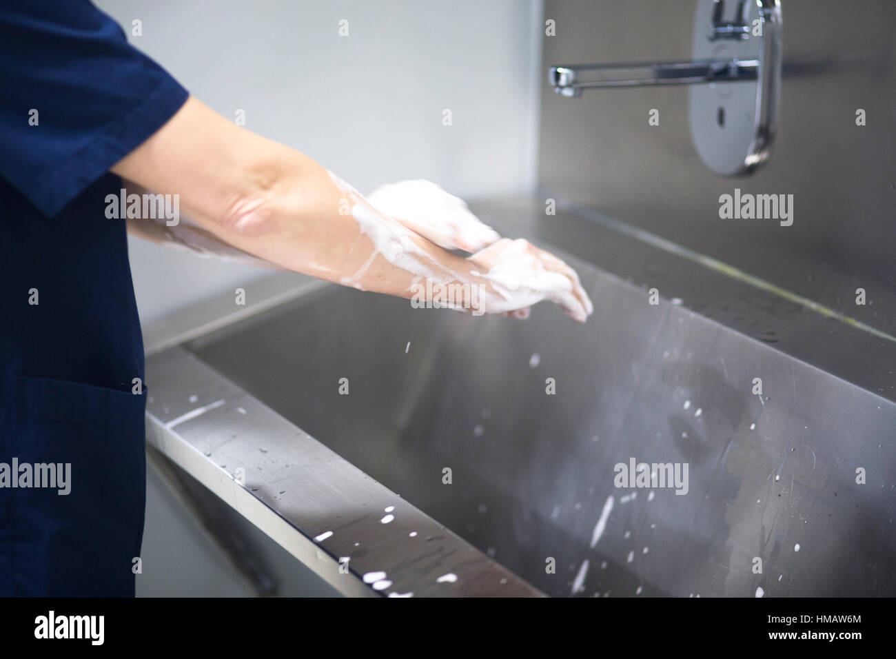 Hospital surgeon washing hands outside ward emergency room operating ...