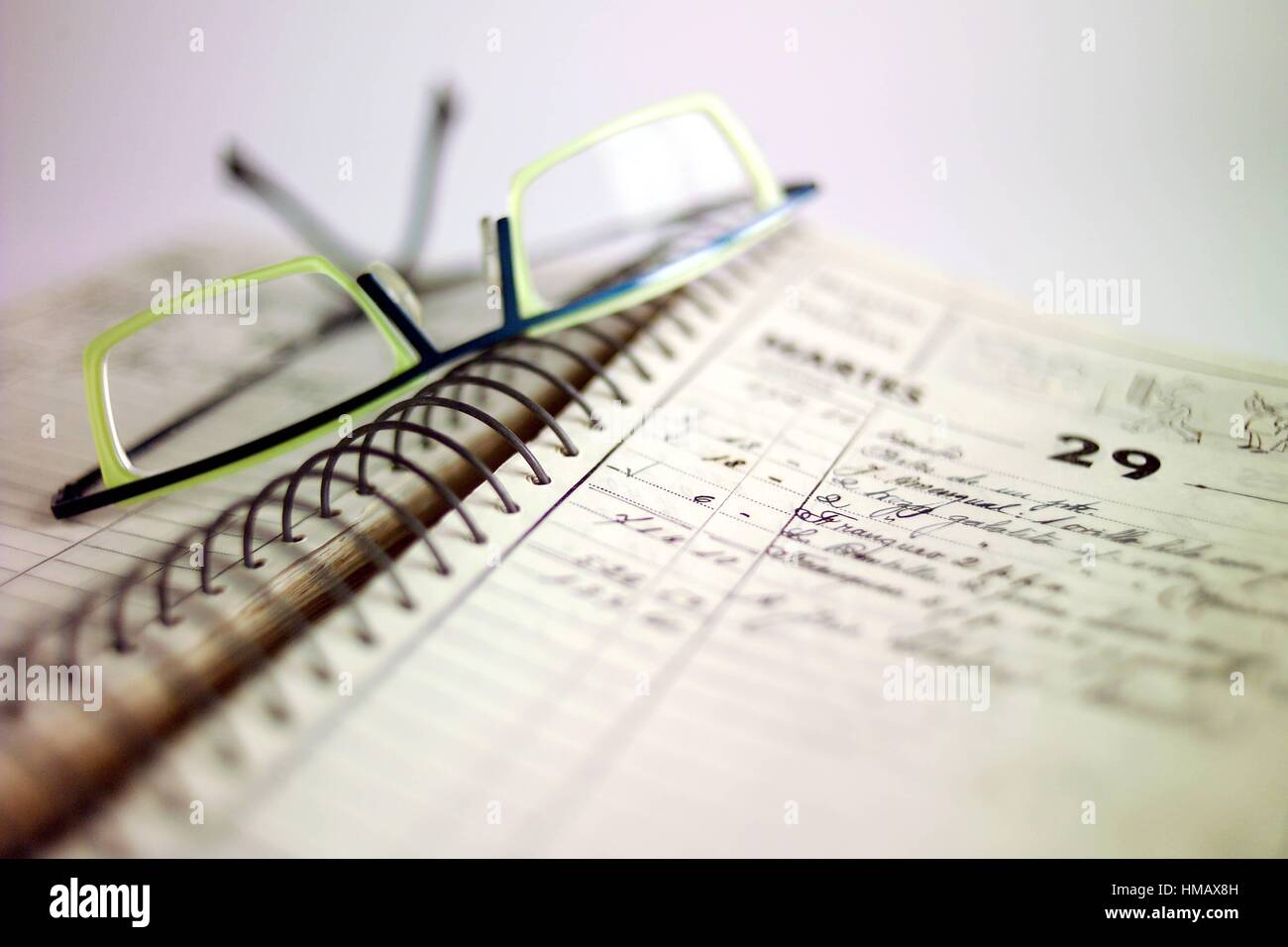 Spiral notebook and glasses Stock Photo - Alamy