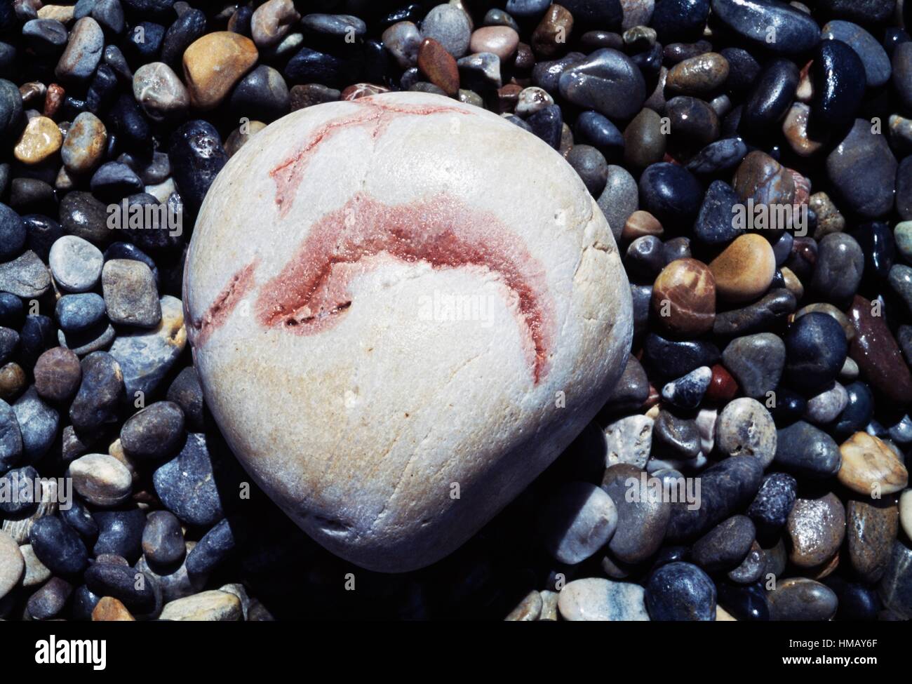 A rock between the coloured stones, Crete, Greece Stock Photo - Alamy
