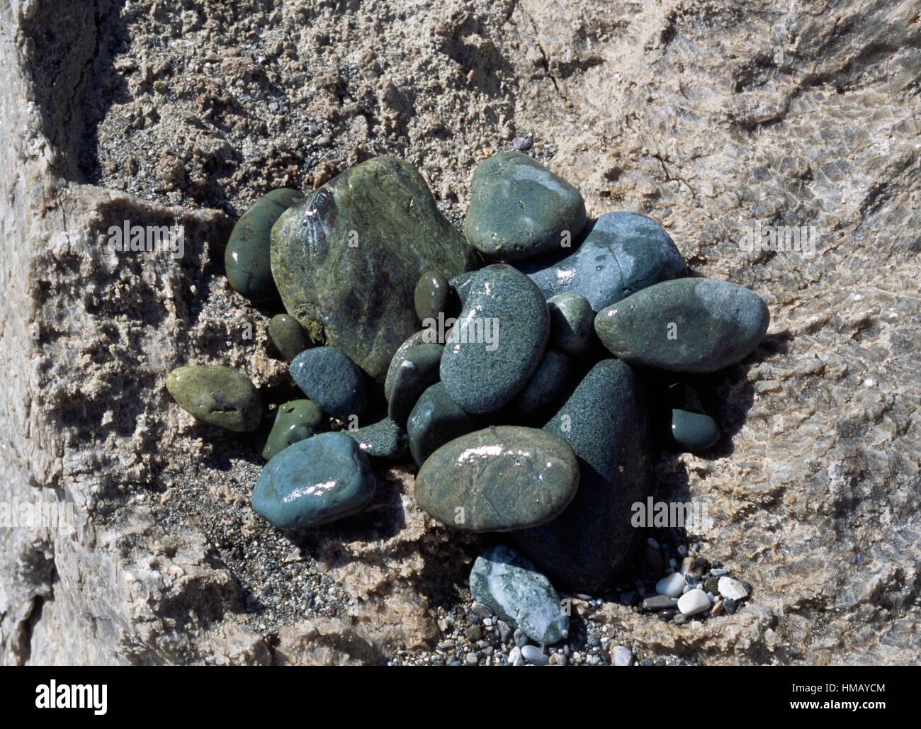 Small rocks and stones piled on a much larger rock, Keratokambos, Crete ...
