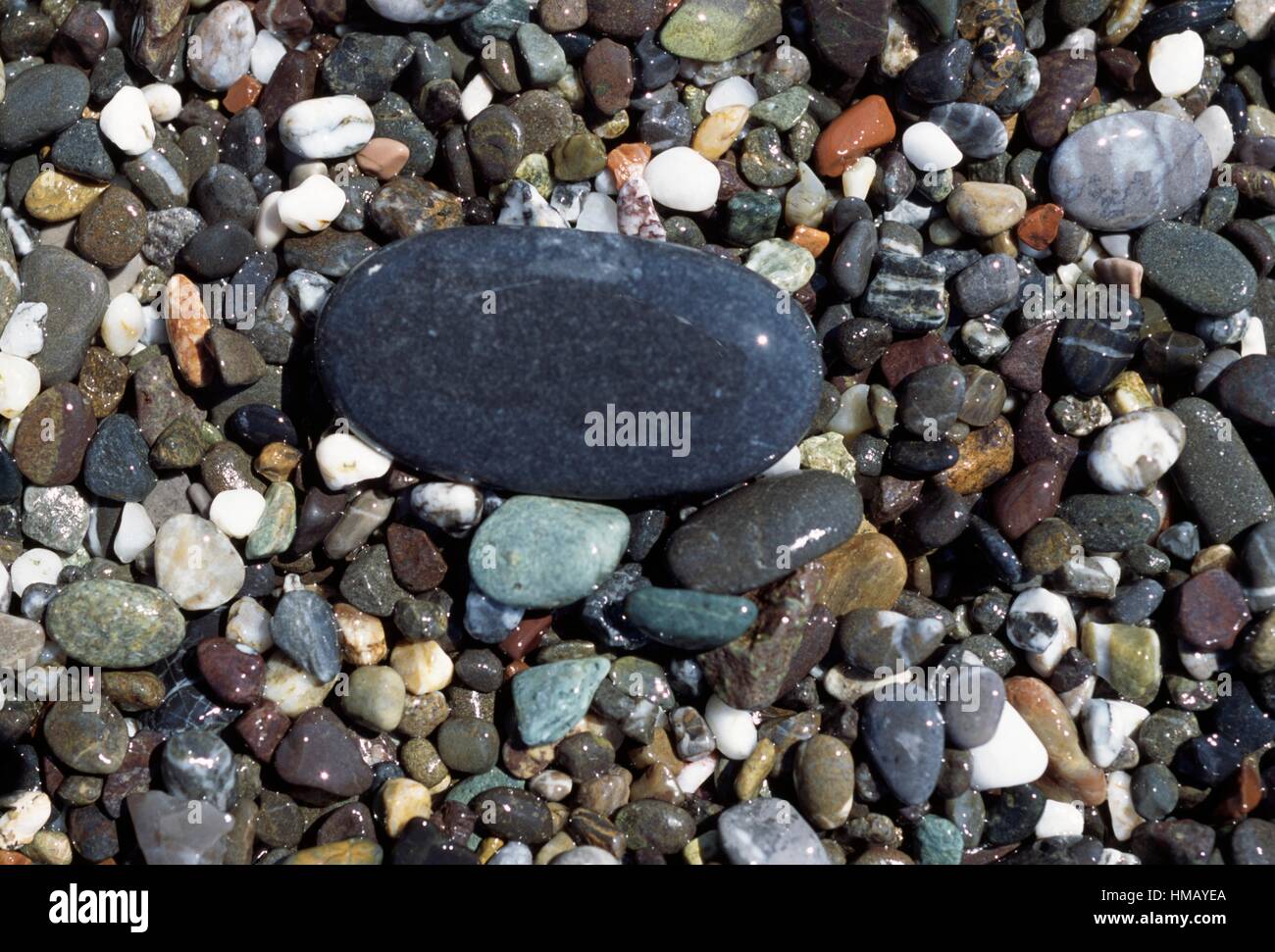 Black rock on gravel, Keratokambos, Crete, Greece Stock Photo - Alamy
