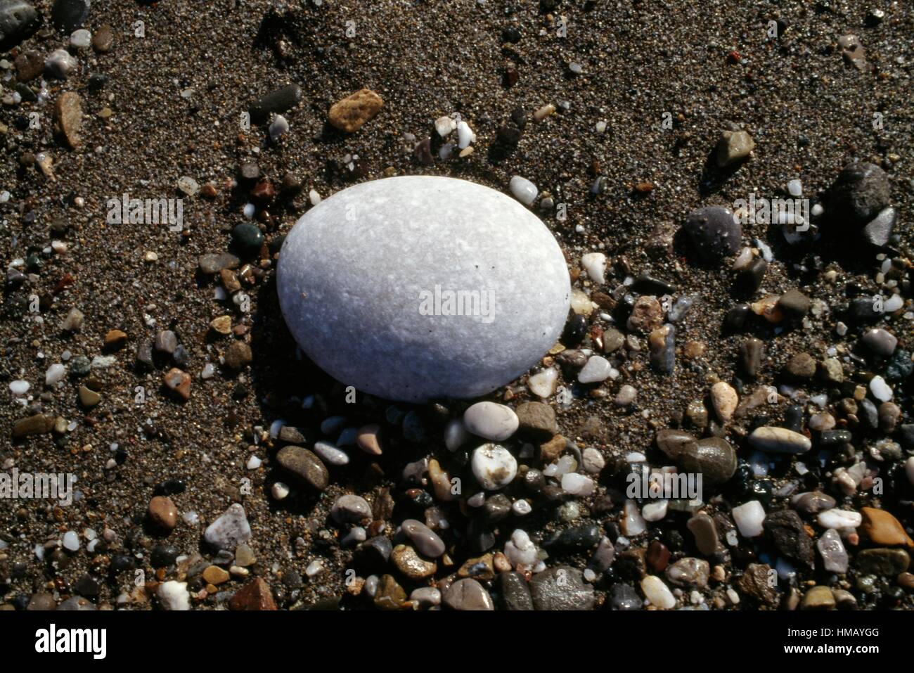 White rock on sand and gravel, Crete, Greece Stock Photo - Alamy