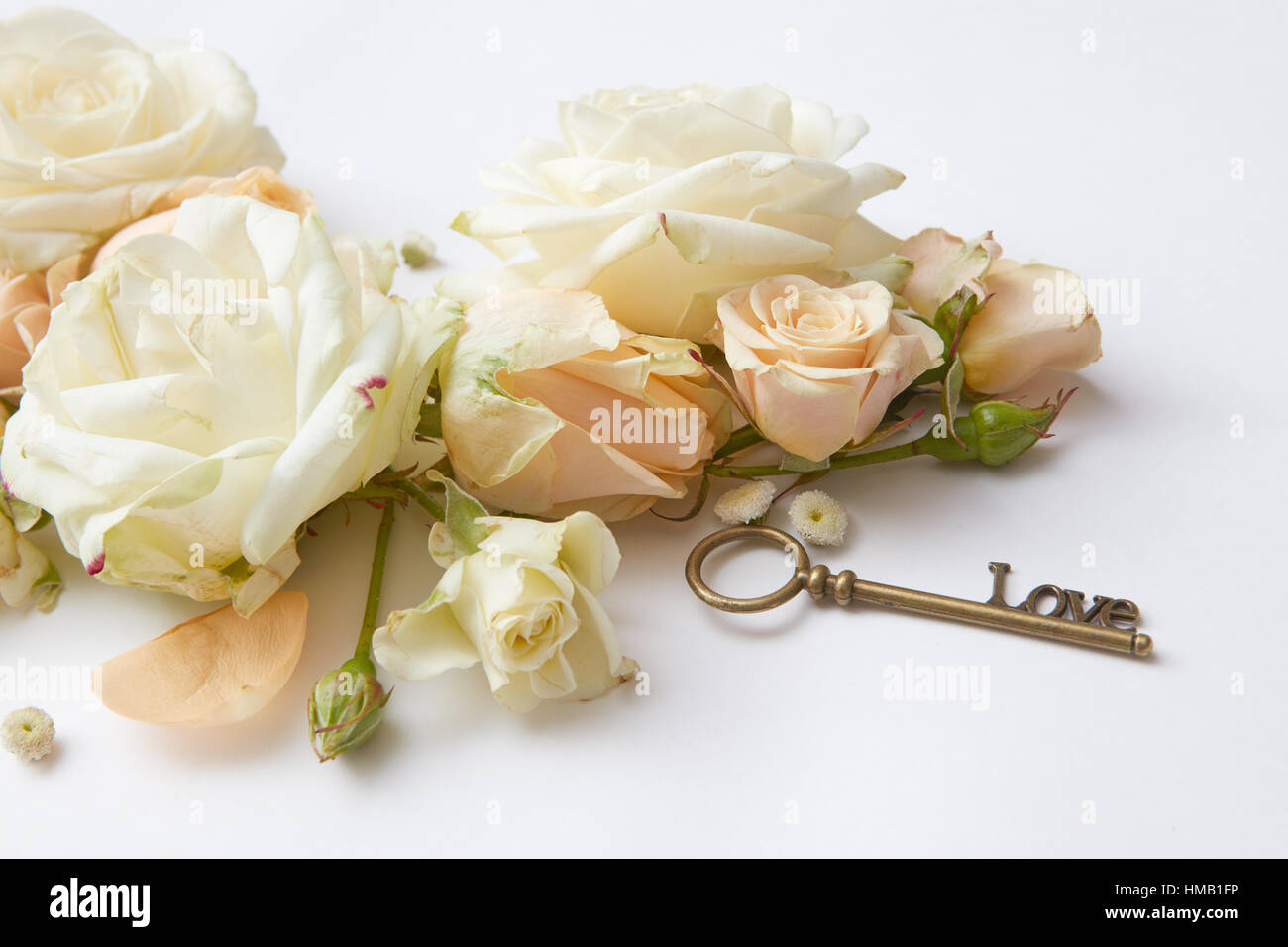 key and bouquet of roses on a white background Stock Photo - Alamy