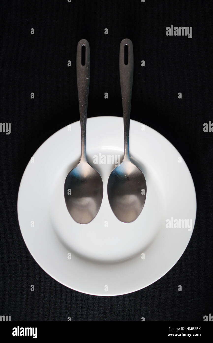 Spoons on plate, laughing face Stock Photo - Alamy