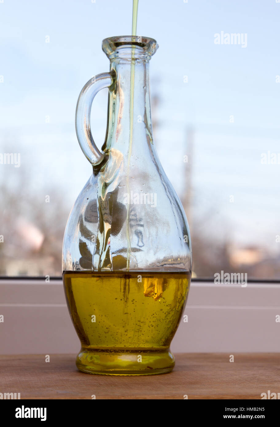Olive oil is poured in a bottle Stock Photo - Alamy