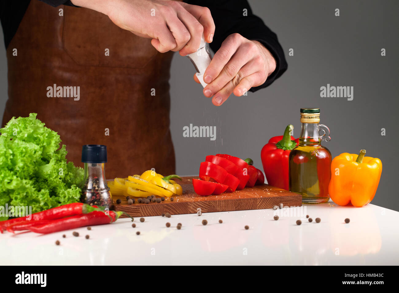 Chef preparing food using salt-shaker Stock Photo - Alamy