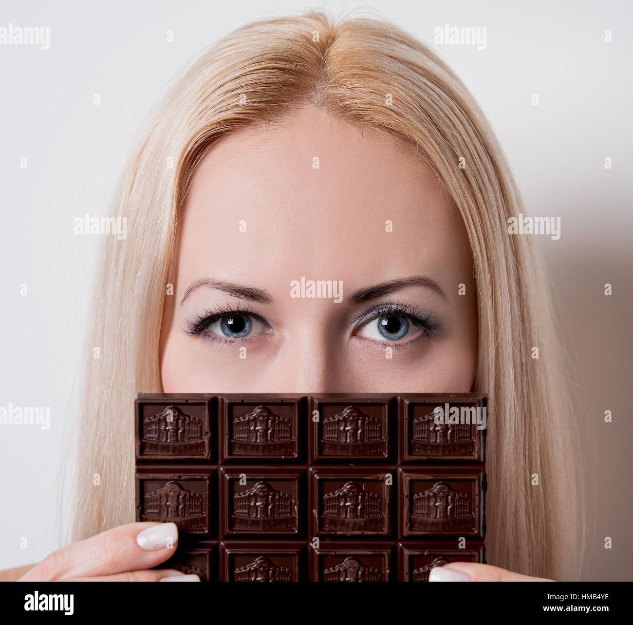 girl hiding behind the chocolate Stock Photo - Alamy