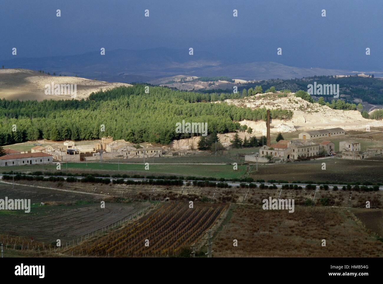 Hilly landscape with forests and buildings in ruins, near Enna, Sicily ...