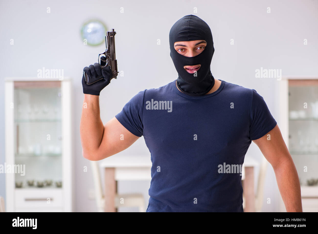 Robber wearing balaclava stealing valuable things Stock Photo - Alamy