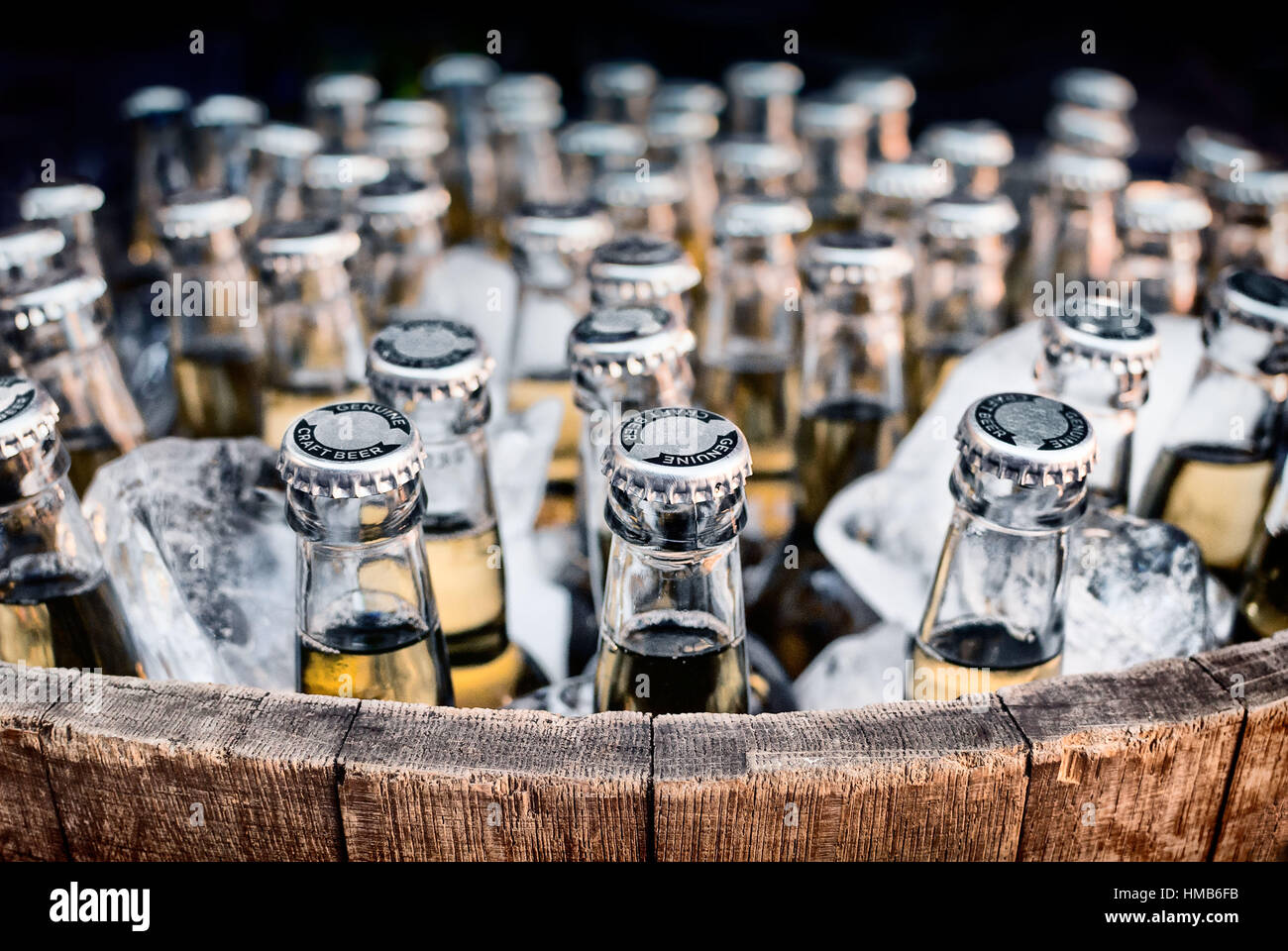 Lots of bottled craft beers in ice in an open wooden barrel Stock Photo ...
