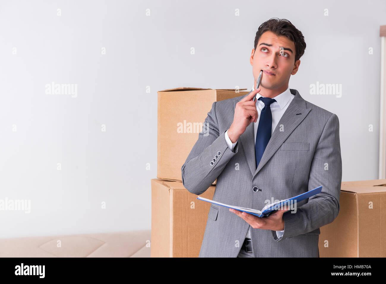 Man signing for the delivery of boxes Stock Photo - Alamy