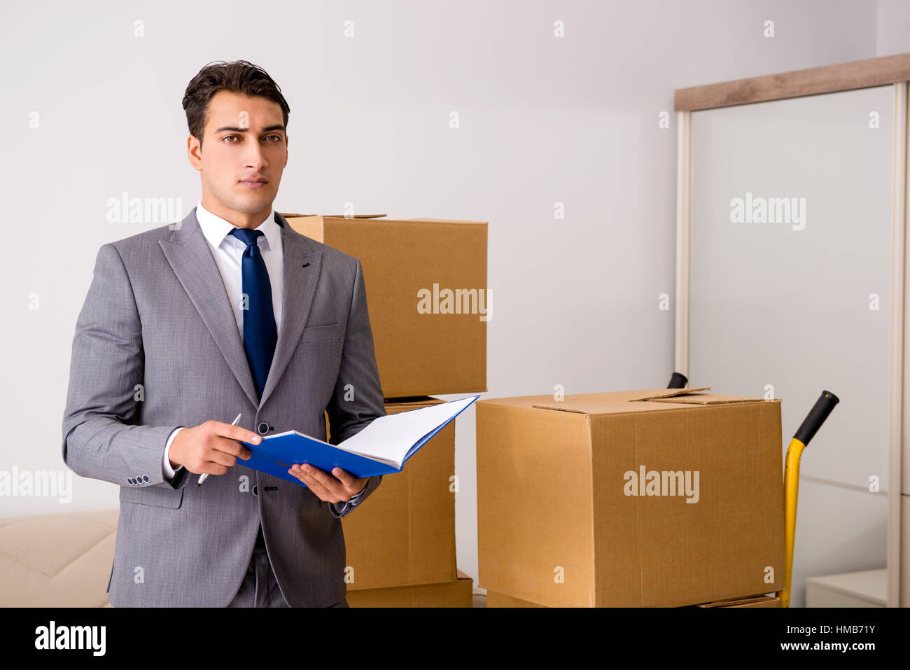 Man signing for the delivery of boxes Stock Photo - Alamy