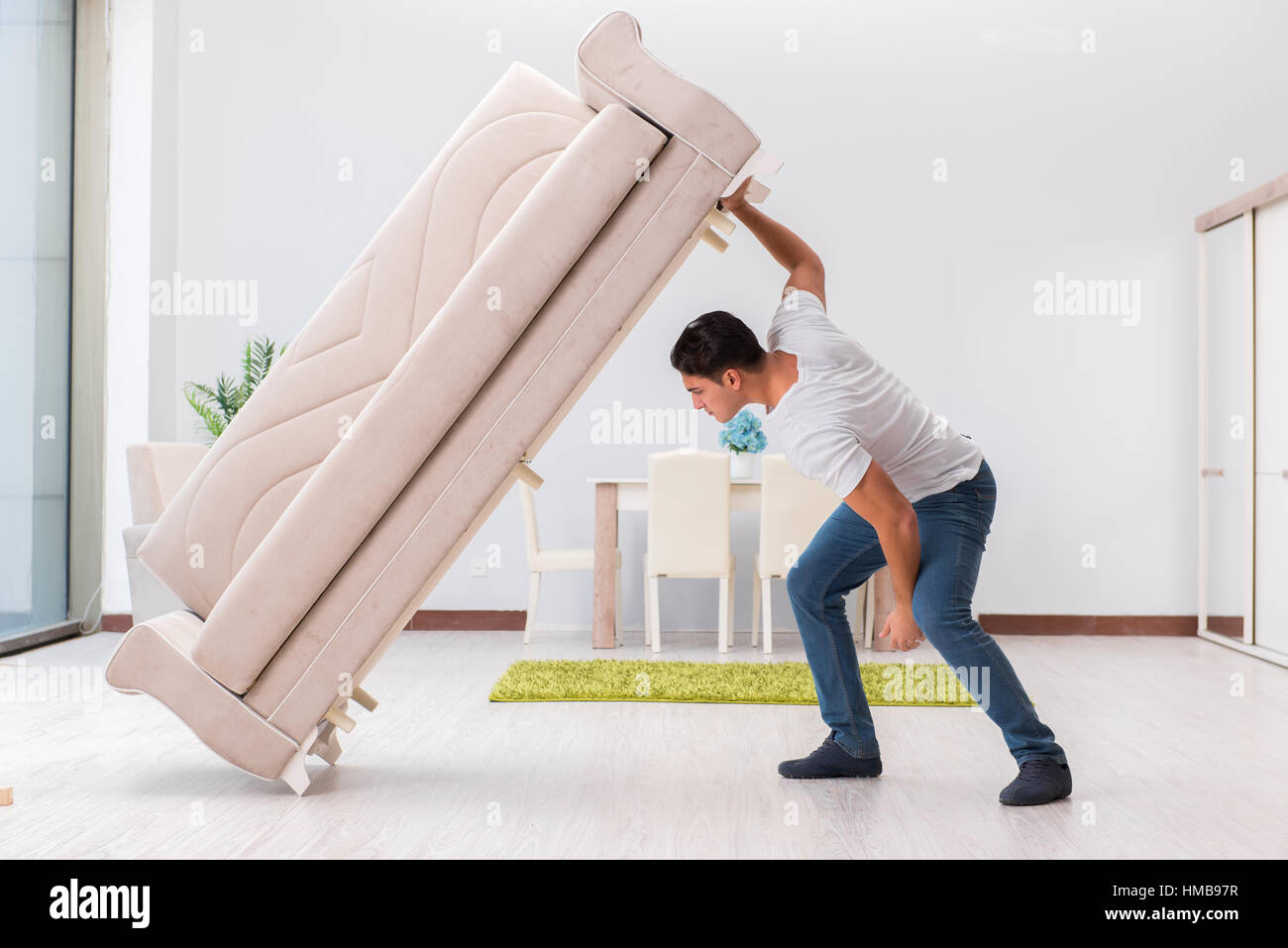 Man moving furniture at home Stock Photo - Alamy