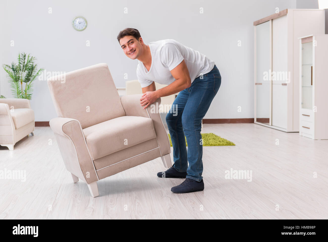 Man moving furniture at home Stock Photo - Alamy