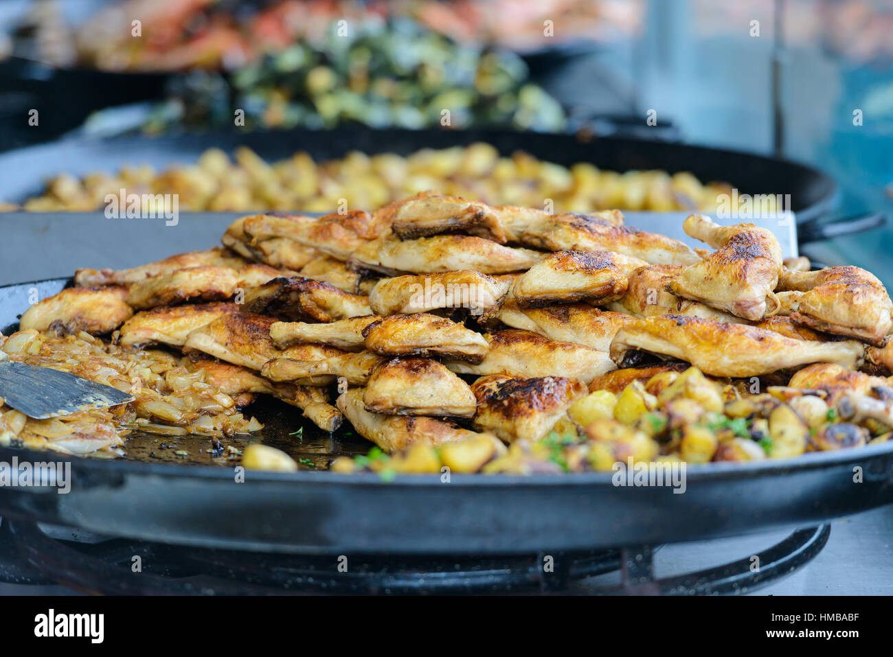 A large dish of fried chicken legs on a market stall in Saint-Palais ...