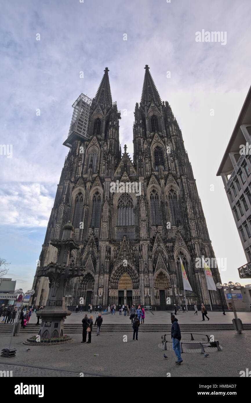 Front facade of Roman Catholic cathedral of Cologne with people in ...