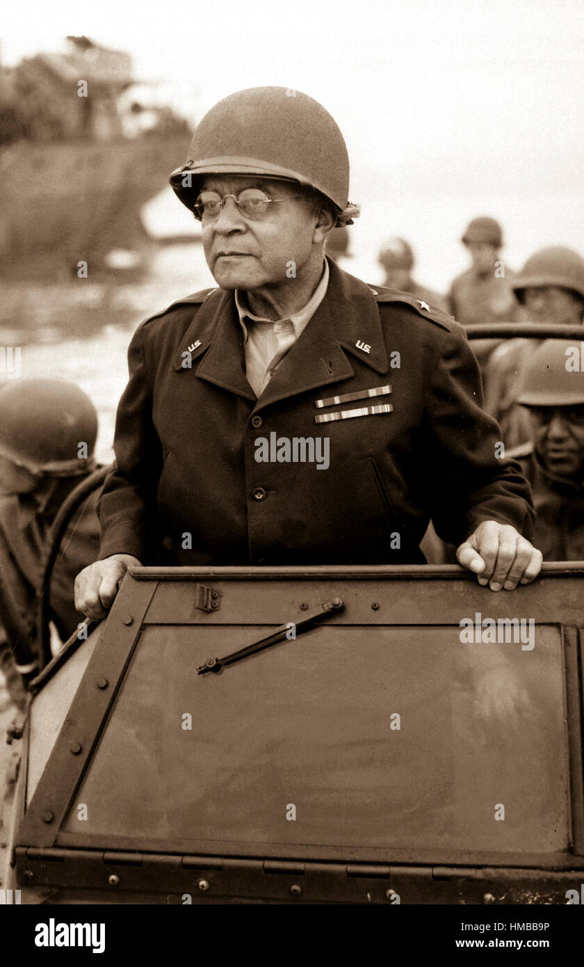 Brig. Gen Benjamin O. Davis watches a Signal Corps crew erecting poles ...