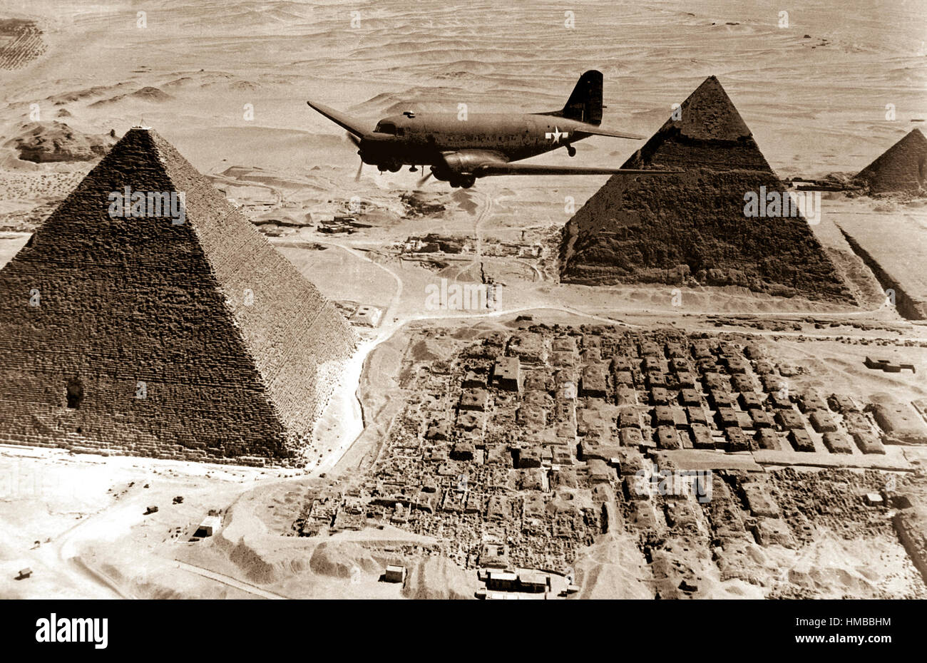 An Air Transport Command plane flies over the pyramids in Egypt. Loaded ...