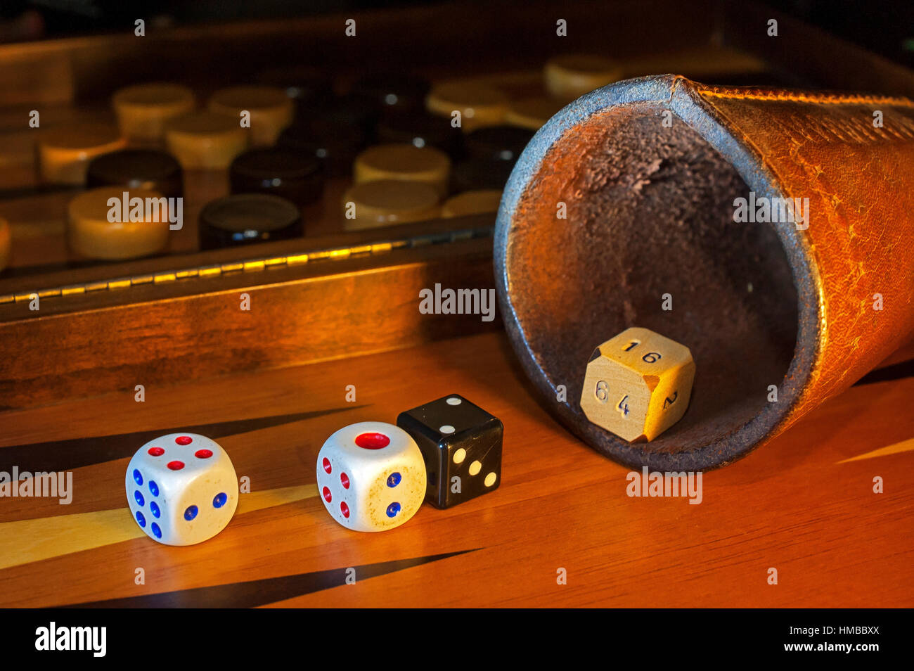 Different type of dice on a gamon board Stock Photo - Alamy
