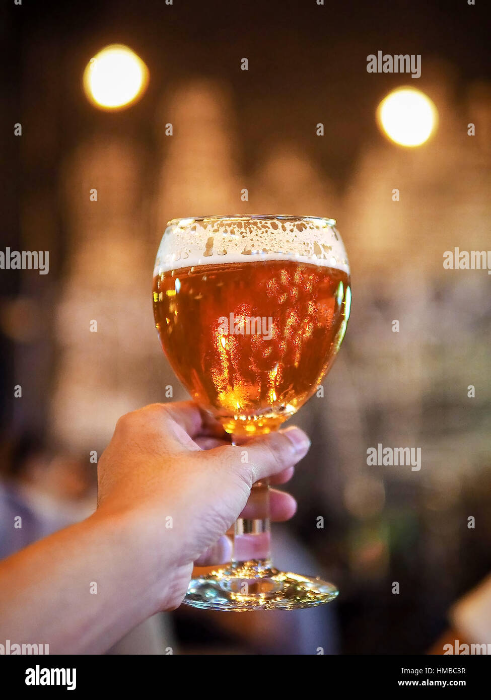 hand holding glass of draft lager beer Stock Photo - Alamy
