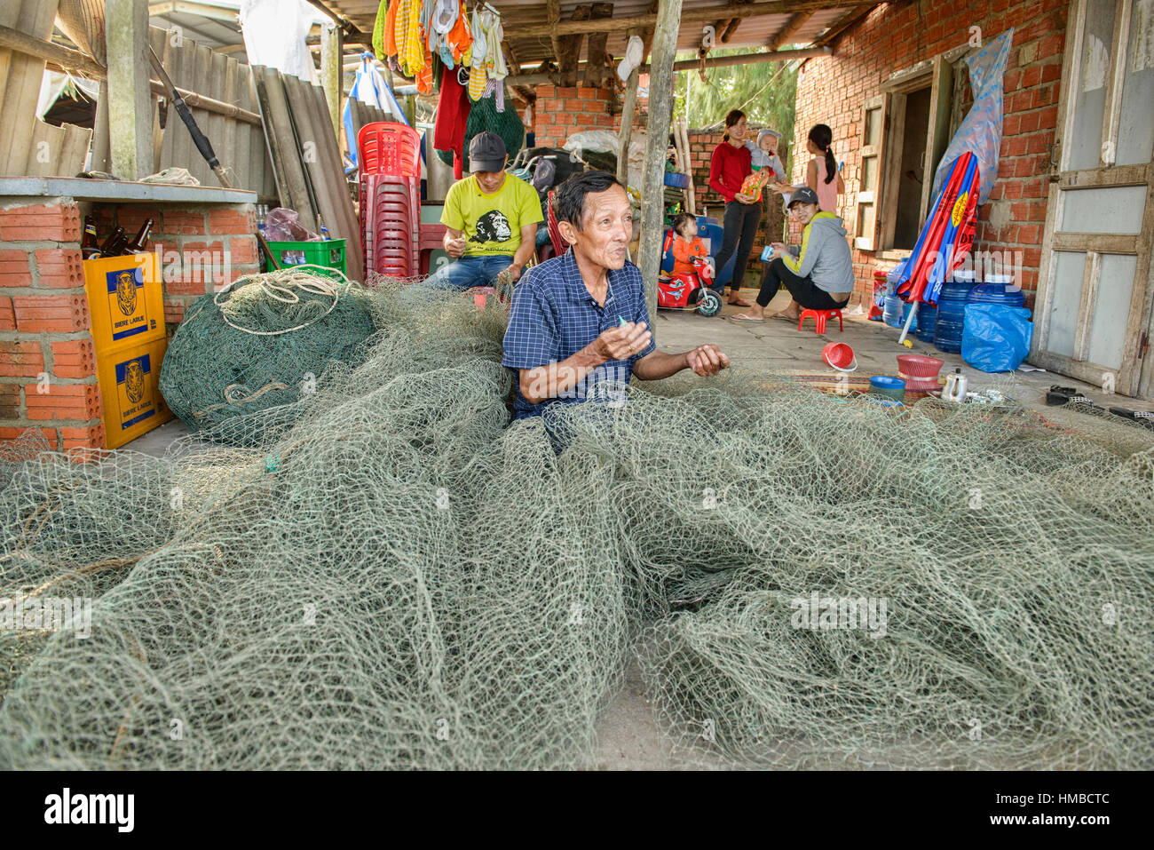 Mending fishing nets, Hoi An, Vietnam Stock Photo - Alamy