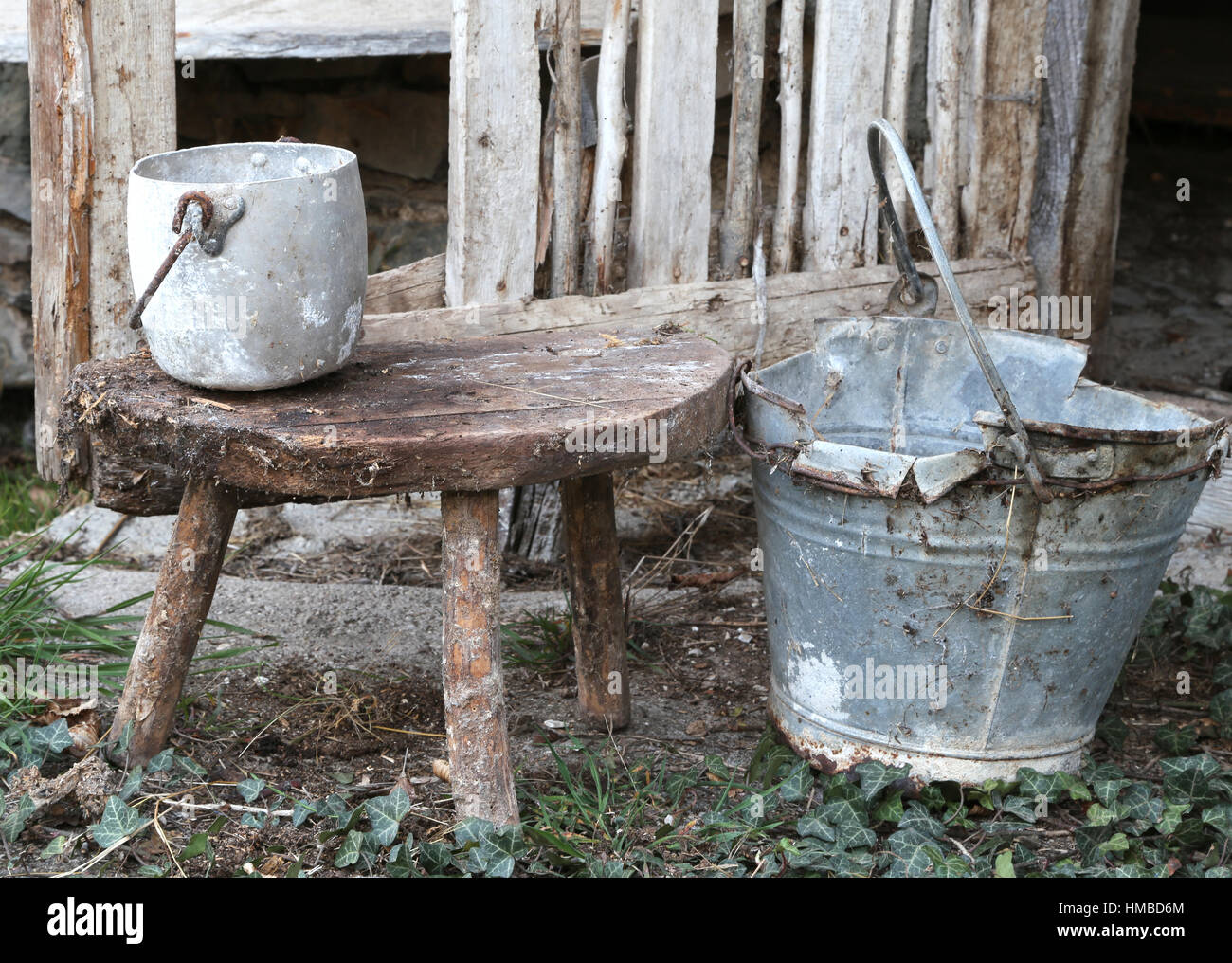 abandoned barn an old broken bucket and an aluminum pan on the wooden ...