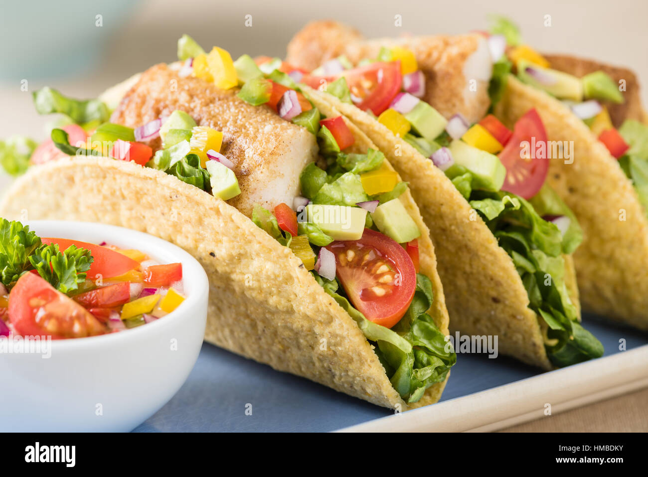Fish tacos shell with tomato, beans, capsicum and avocado salsa Stock ...