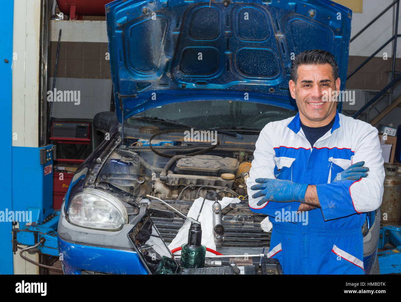Abstract and conceptual of work, tired Car mechanic fixing an engine in ...