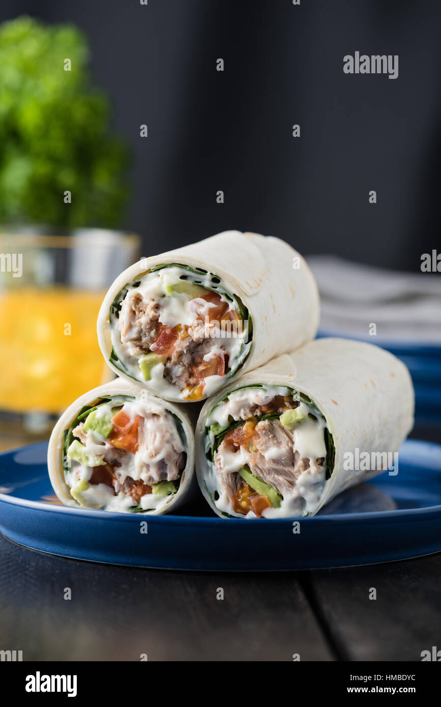 Tuna burritos with avocado tomato and mayonnaise on rustic background ...