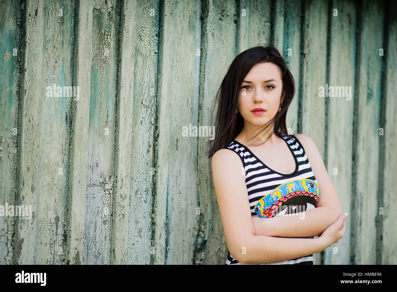 Brunette model girl at dress with stripes background cian wooden ...