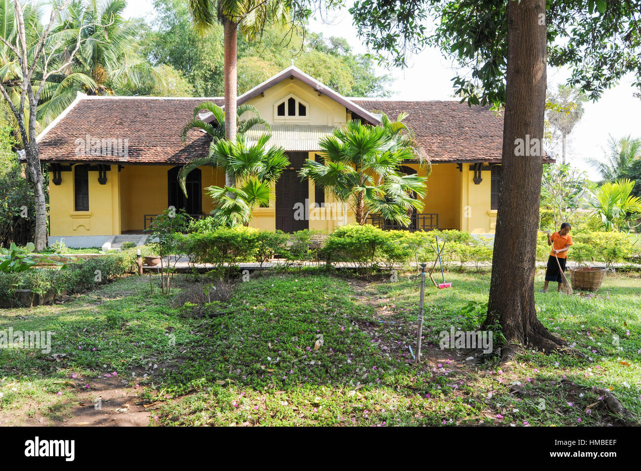 Don Khon, Laos - 25 January 2012: woman raking in the garden of a ...