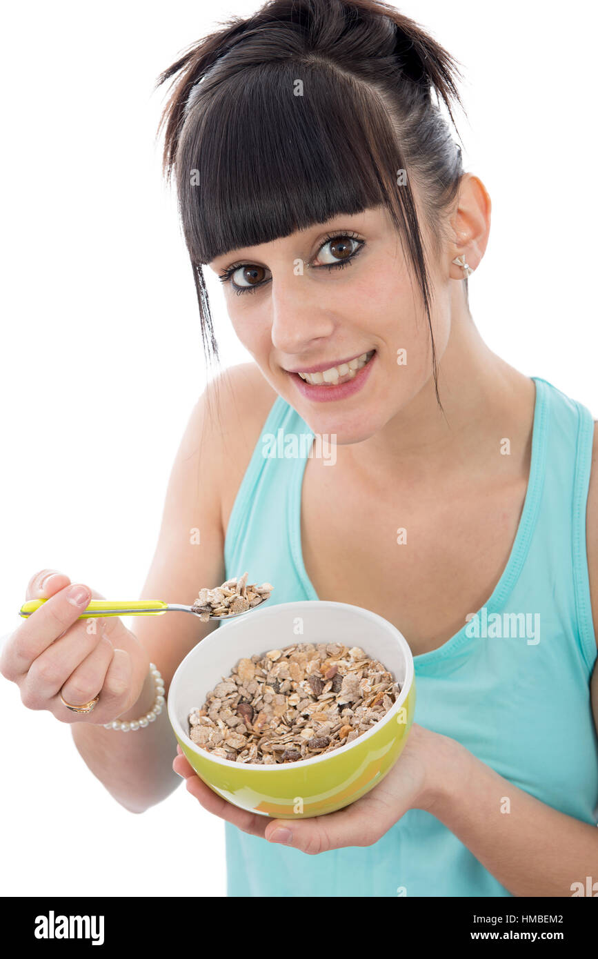 Young brunette girl eating bowl of healthy breakfast cereal Stock Photo - Alamy