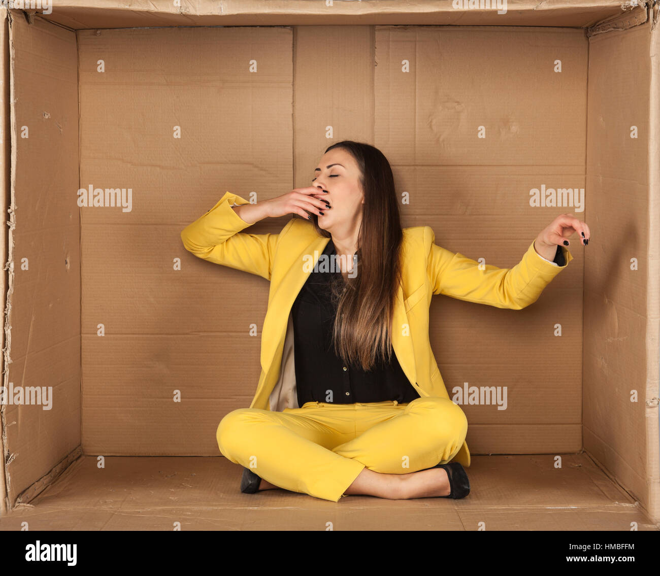 lazy girl in an empty box Stock Photo - Alamy