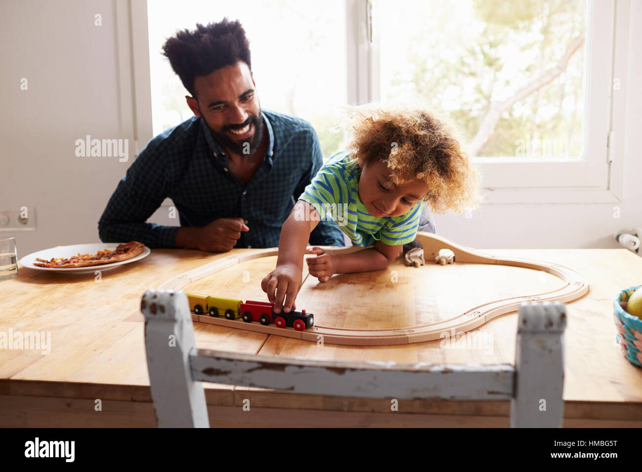Father And Son Playing With Toy Train Set Stock Photo - Alamy