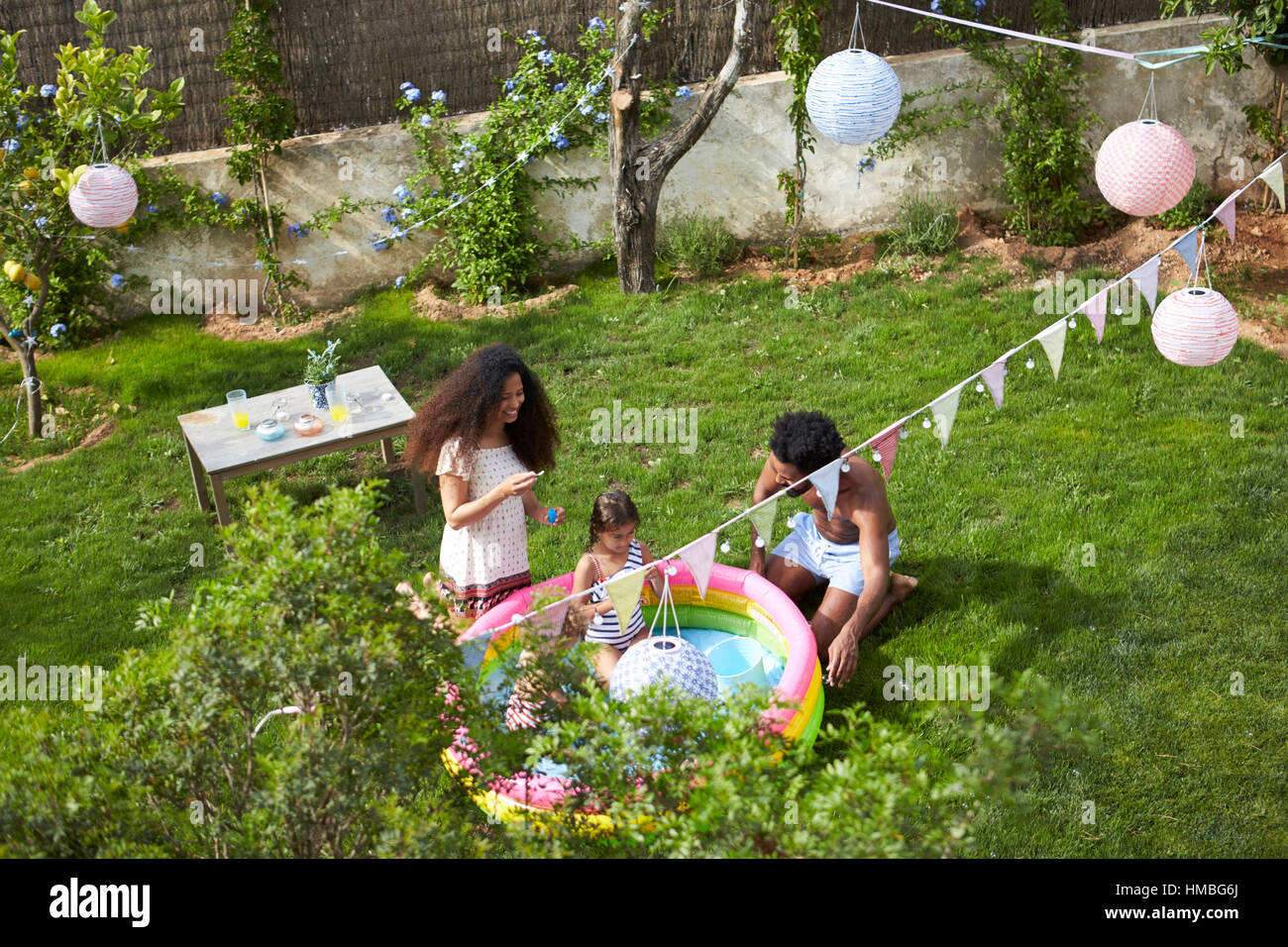 Overhead View Of Family Having Fun In Garden Paddling Pool Stock Photo ...