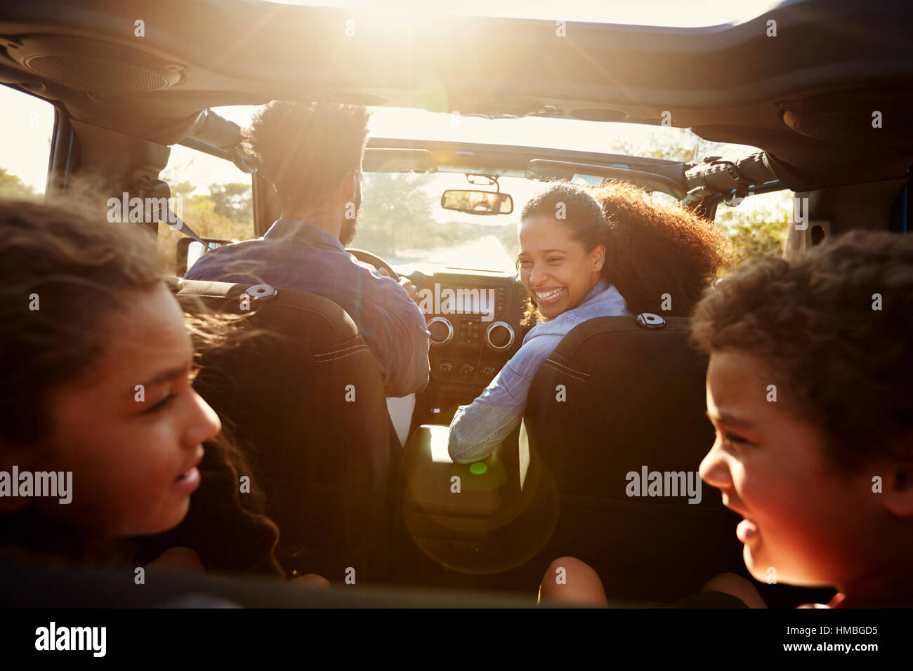Happy family on a road trip in their car, rear passenger POV Stock ...